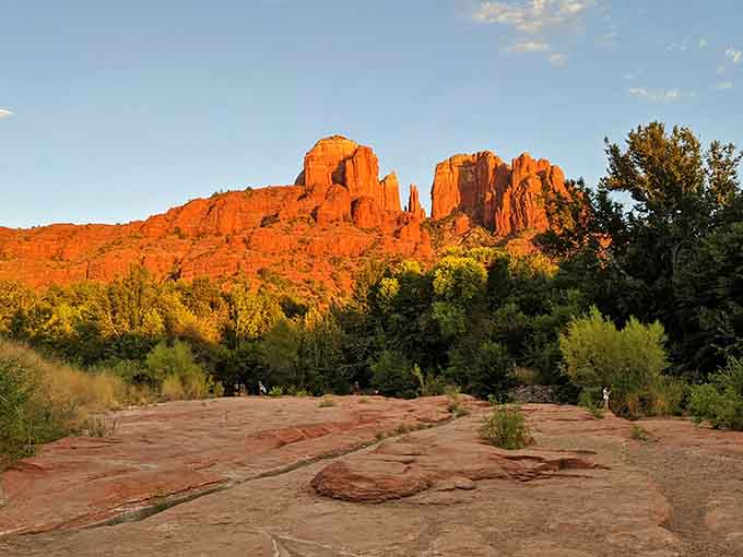 Sunset paints Cathedral Rock in fiery orange hues that would make even Ansel Adams reach for his camera equipment.