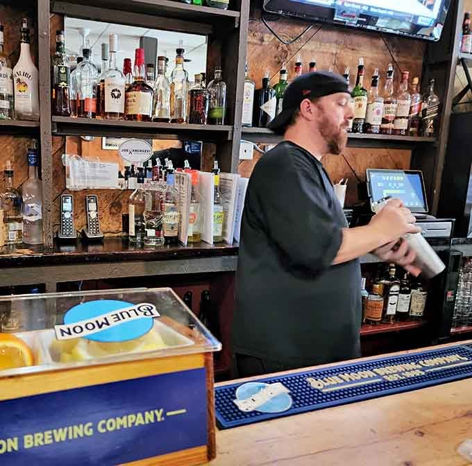 The bartender keeps things flowing smoothly, ensuring your beer stays cold and your wing supply stays steady.