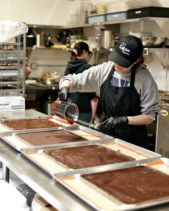 Real artisans at work, pouring liquid chocolate with the precision of surgeons performing delicate, delicious operations.