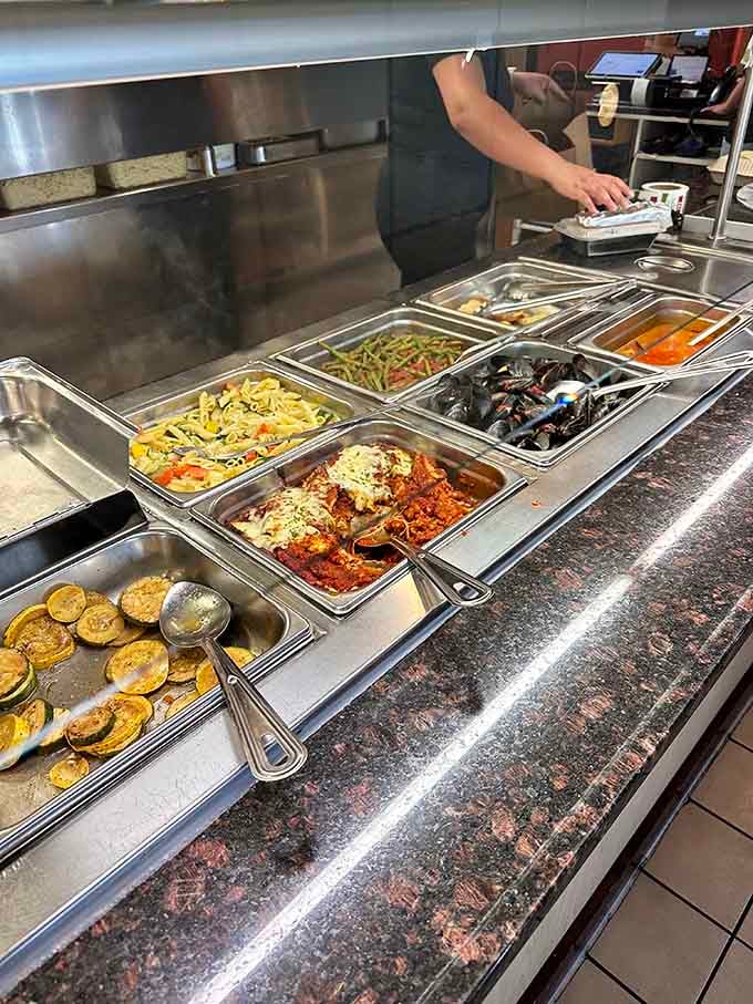 The steam table showcases variety, from vegetables to chicken parmigiana, each tray promising different delicious possibilities ahead.