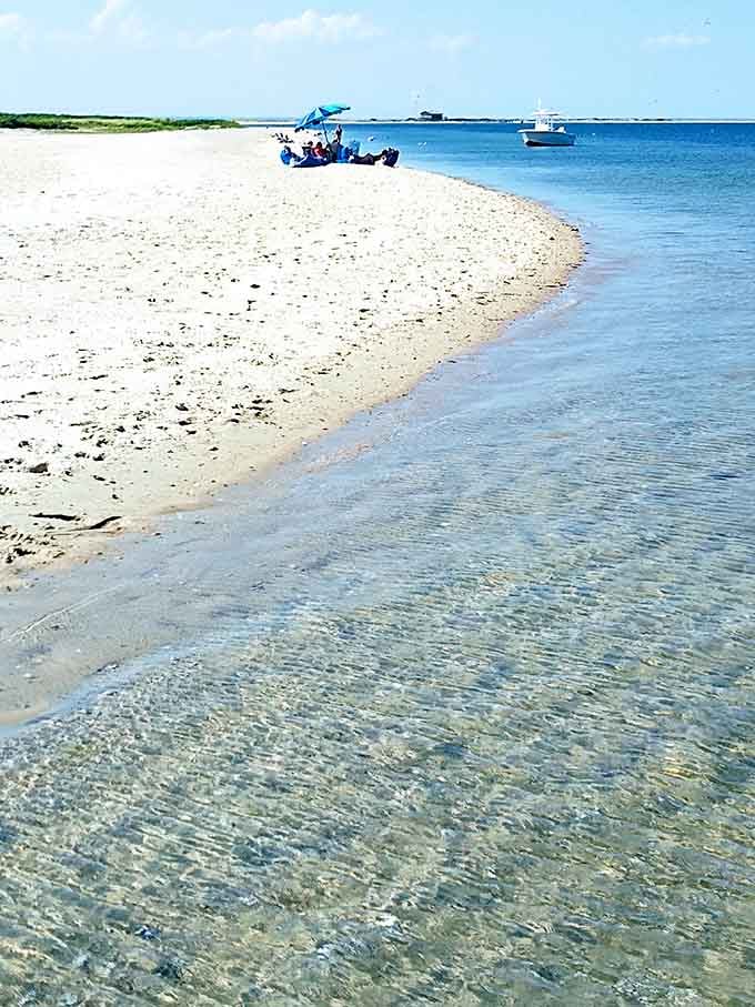 Crystal-clear shallows reveal every ripple and grain beneath the surface, water so transparent it makes swimming pools look murky.