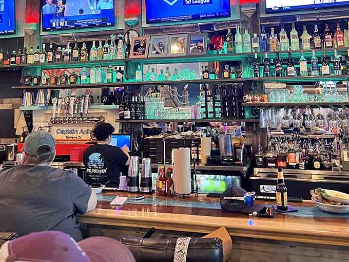 The bar gleams with possibilities, backed by enough bottles to keep any coastal celebration going strong all night.