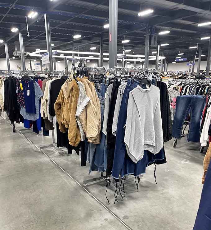 Clothing racks stretching across the warehouse floor like a department store decided to share the wealth instead.