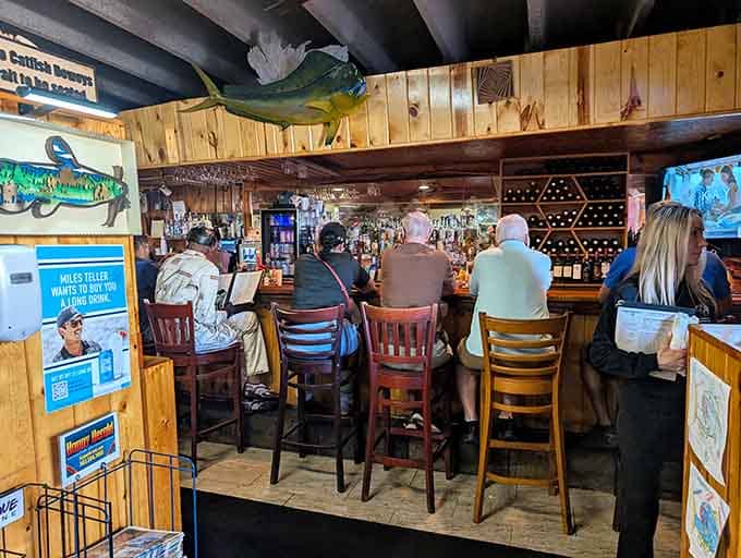 The bar area where regulars gather, swap stories, and debate who ate the most catfish today.