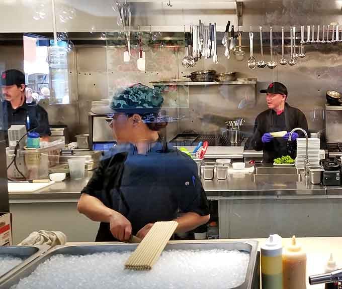 The open kitchen lets you watch skilled chefs work their magic, turning fresh ingredients into edible art right before your eyes.