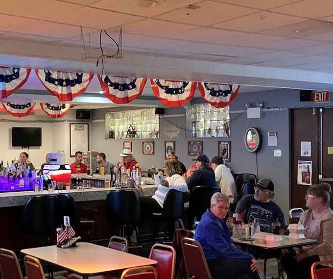 The long bar lined with stools invites conversation, laughter, and the kind of camaraderie that makes strangers friends.