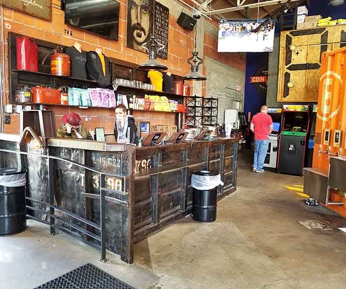 That rustic counter isn't just for show; it's your gateway to craft beer happiness and arcade glory.