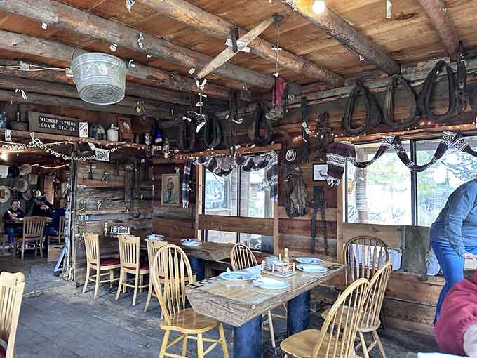 Long wooden tables under rustic beams create the kind of atmosphere where conversations flow as freely as the incredible food.