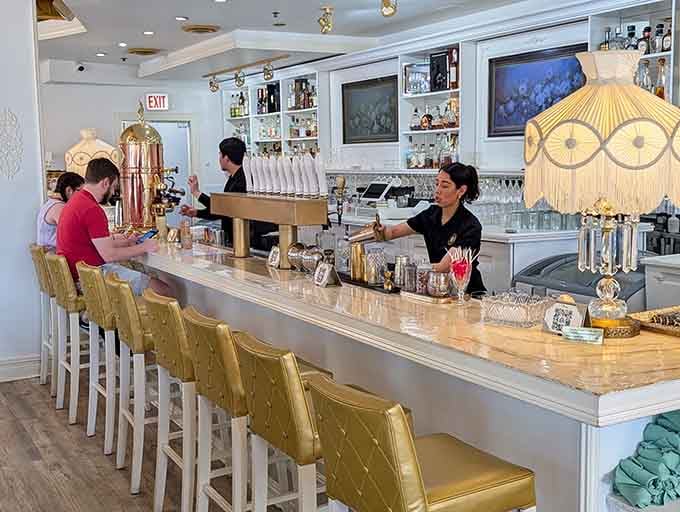 Bar seating with that elegant lampshade overhead where you can watch the magic happen while sipping something delicious.