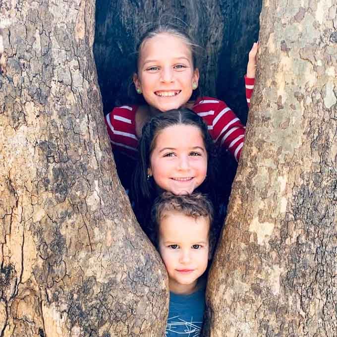 Young adventurers discover that hollow trees make perfect photo ops and memories that'll last way beyond childhood years.