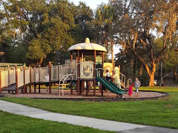 Golden hour transforms this peaceful playground into a Norman Rockwell painting with modern safety equipment and better lighting.