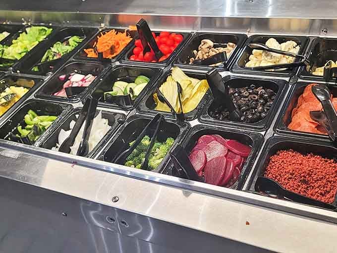 The salad bar offers fresh vegetables and toppings, giving you permission to feel virtuous before dessert round two.