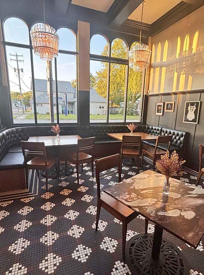 Tufted banquets, statement chandeliers, and windows that frame the town like living artwork on the walls.