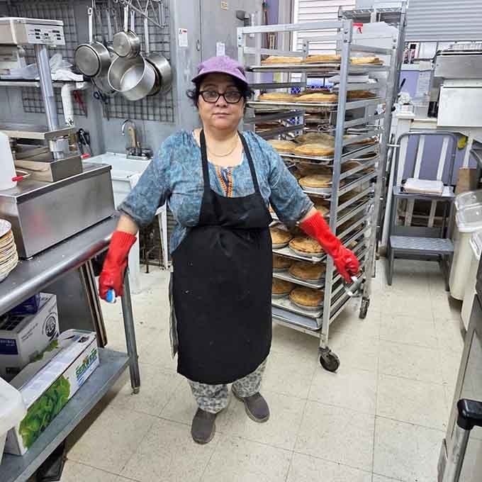 Behind the scenes where the real work happens, racks of pies cooling like edible works of art.