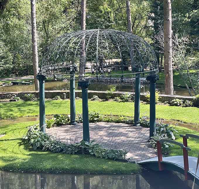 An elegant gazebo sits beside the creek, because every proper castle needs a spot for contemplating your kingdom.