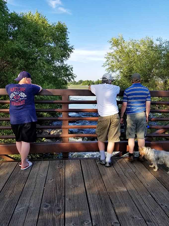 Three friends, one view, and a dog who's clearly living their best life at the overlook.