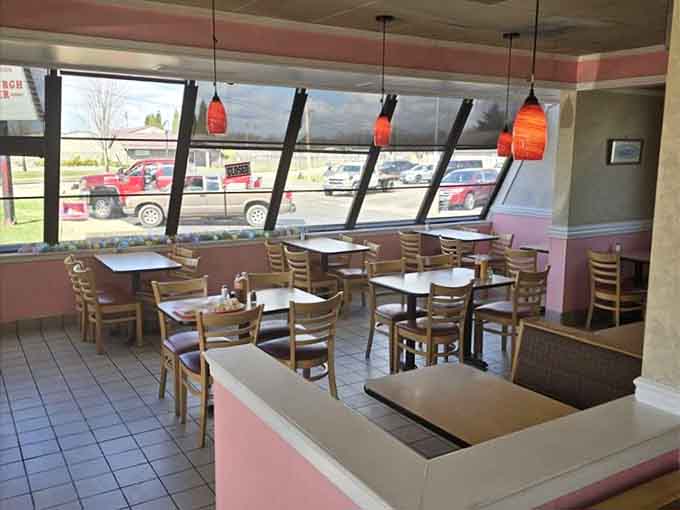 The dining room offers plenty of seating with those angled windows, because even architecture wants a good view here.