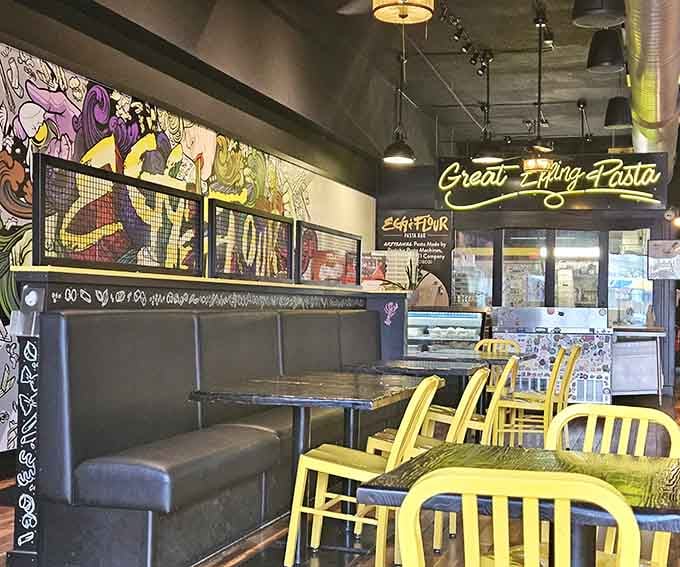 Industrial-chic meets playful energy where neon signs and booth seating create the perfect casual dining atmosphere.