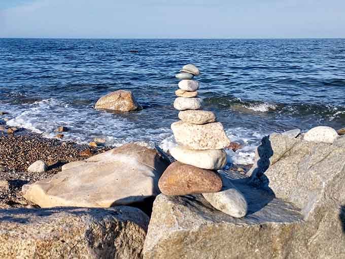 Someone's patient handiwork creates a zen moment by the shore, balancing stones like a meditation in three dimensions and pure focus.