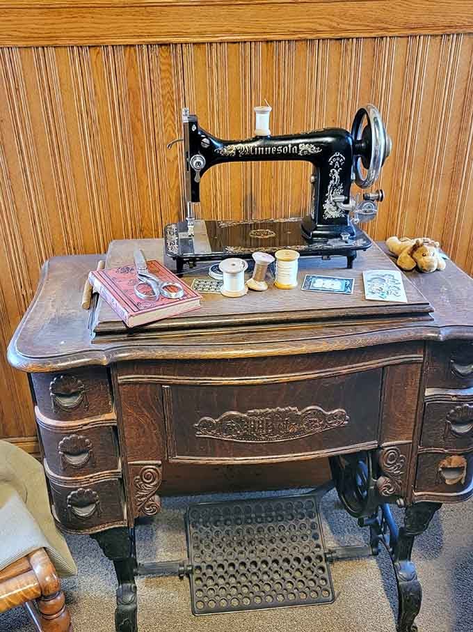 The vintage sewing machine reminds us that creating clothing once required actual skill, patience, and strong fingers.