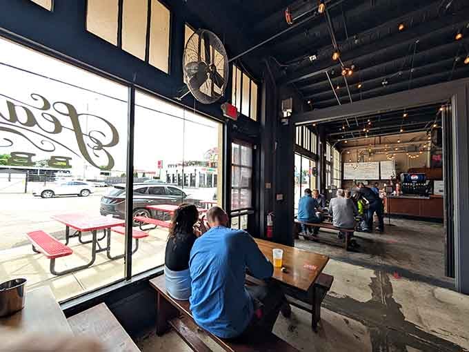 Communal tables and string lights set the stage for meals that turn strangers into friends over smoked meat.