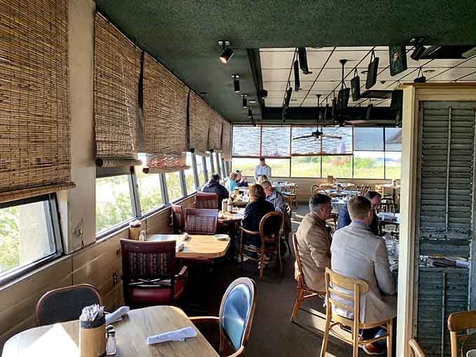 Bamboo shades filter the afternoon sun perfectly, keeping the dining room comfortable while preserving those million-dollar water views.