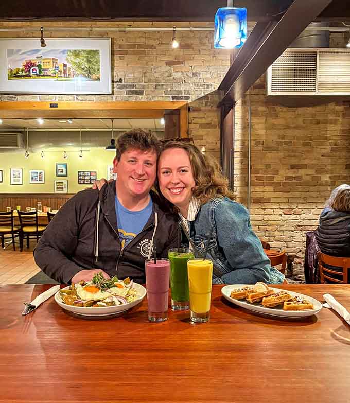 Happy diners enjoying colorful juices and fresh plates, living their best brunch life in downtown Sheboygan.