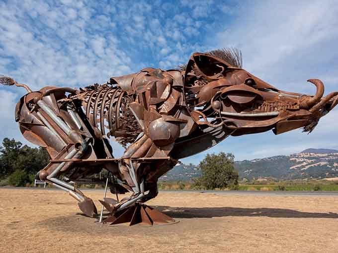 Constructed from farm equipment parts, this charging boar captures pure kinetic energy frozen in rusted steel and determination.