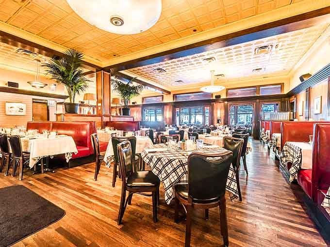 Red leather booths and warm wood tones create an inviting space where memorable meals become cherished traditions.