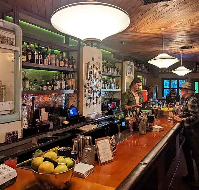The bar glows with retro lighting and fresh citrus, where skilled bartenders craft drinks worth the Hollywood pilgrimage.