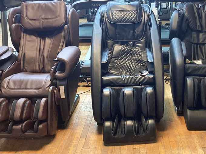 Massage chairs standing ready like personal spa attendants, offering luxury relaxation at discount store prices.
