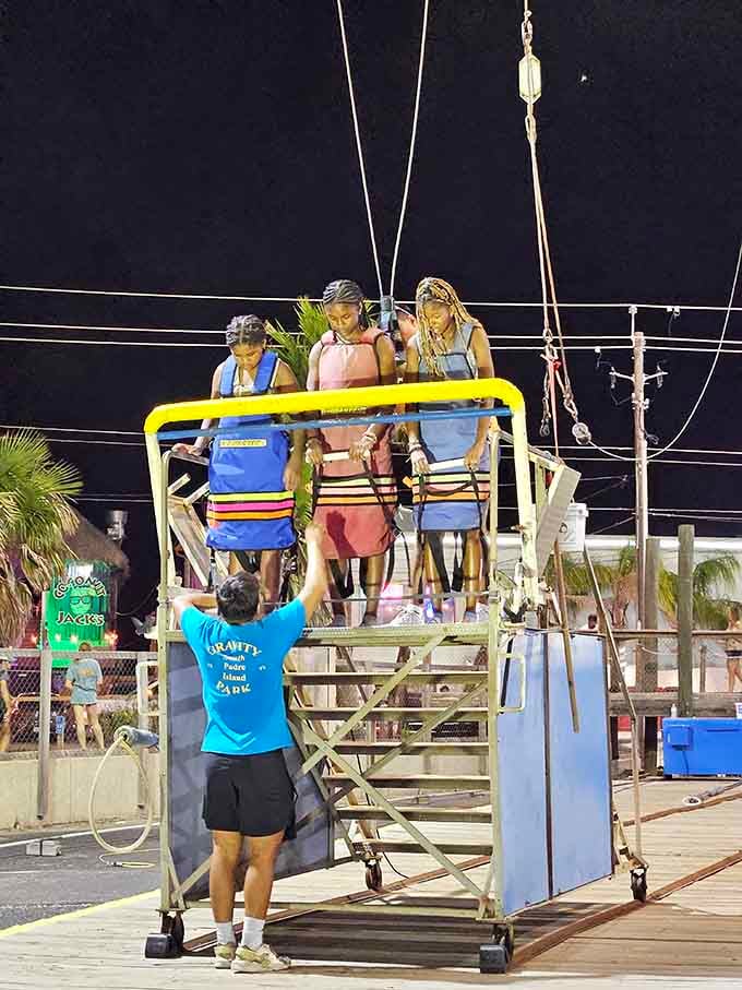 The Skyfall ride illuminated against the night, looking like something from a futuristic carnival fever dream come true.