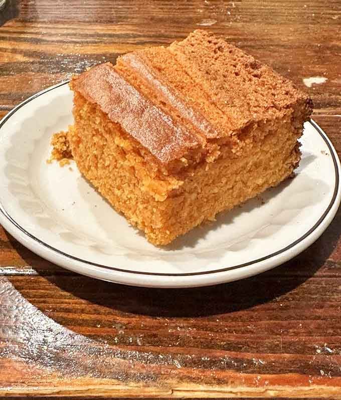 This towering slice of cornbread with its sugar-dusted top is basically edible architecture.