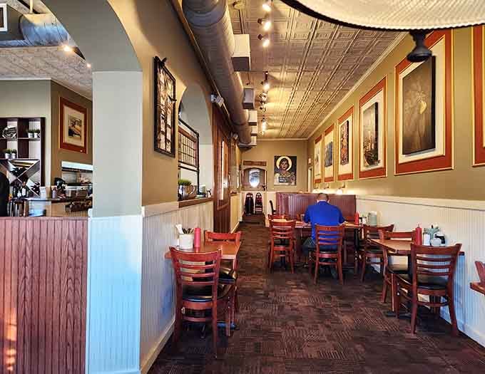 A dining room that manages to feel both spacious and intimate, with framed artwork adding character to every wall.