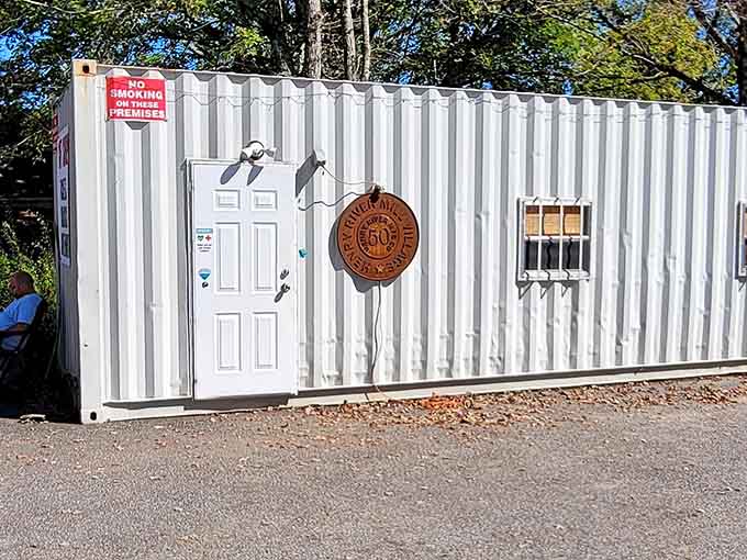 A shipping container serves as the modern gift shop, proving that preservation requires some creative problem-solving.