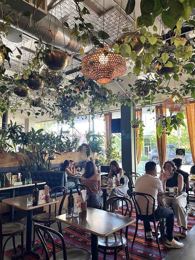 Diners surrounded by greenery, lost in conversation, completely forgetting they're still in Portland somehow.