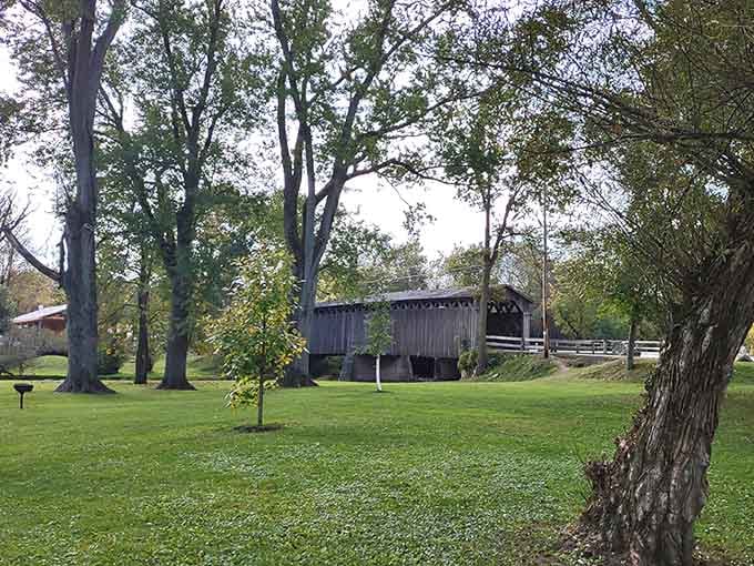 Framed by ancient trees, the bridge sits like a beloved grandfather in the family photo album.