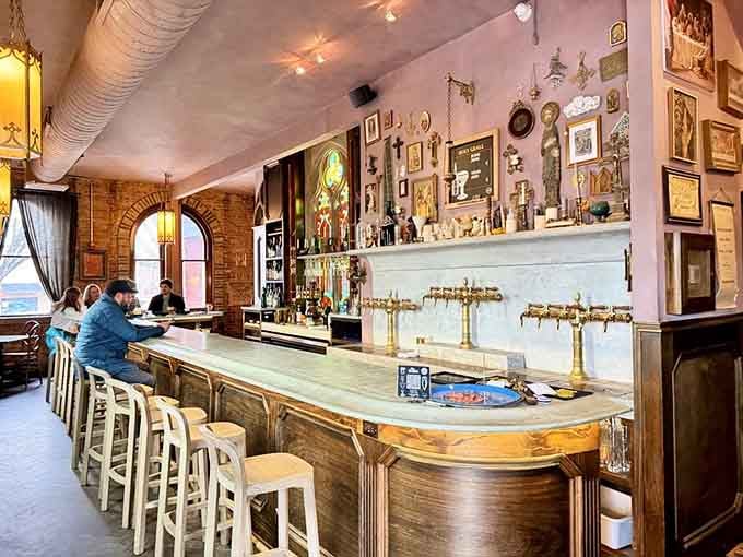 The impressive bar stretches along the wall, showcasing enough Belgian taps to make any beer enthusiast genuinely emotional.
