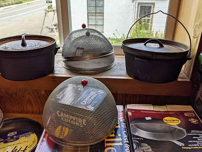 Cast iron cookware sits ready to help you channel your inner pioneer chef over the campfire tonight.