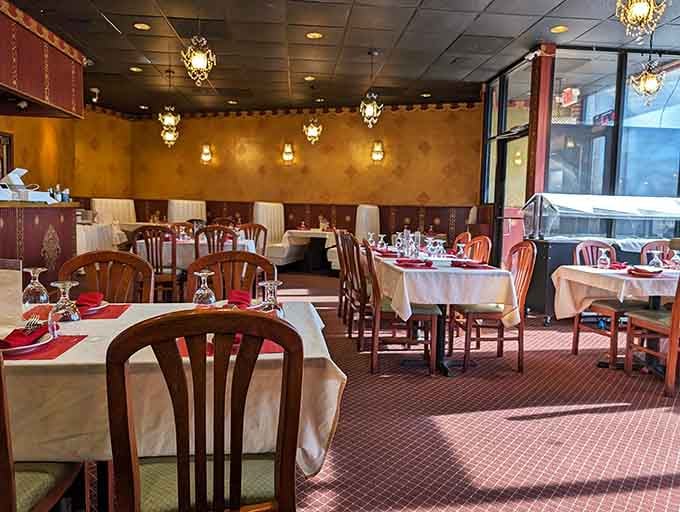 Spacious dining room with white tablecloths and comfortable seating that invites you to settle in for a proper feast.
