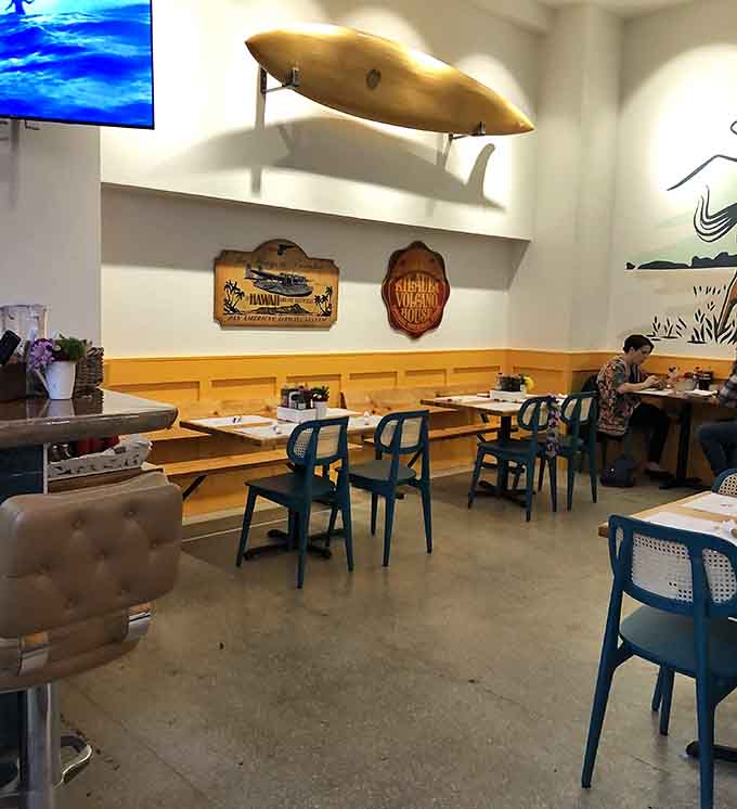 Surfboards on the walls and cheerful seating below, this dining room makes every meal feel like a celebration.
