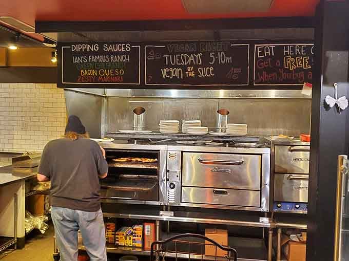 Behind the scenes, the pizza wizards work their magic turning dough and dreams into edible masterpieces.