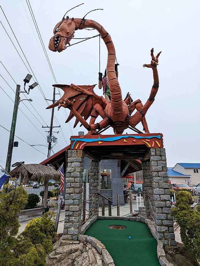A massive dragon looms overhead because apparently someone decided mini golf needed more nightmare fuel options.