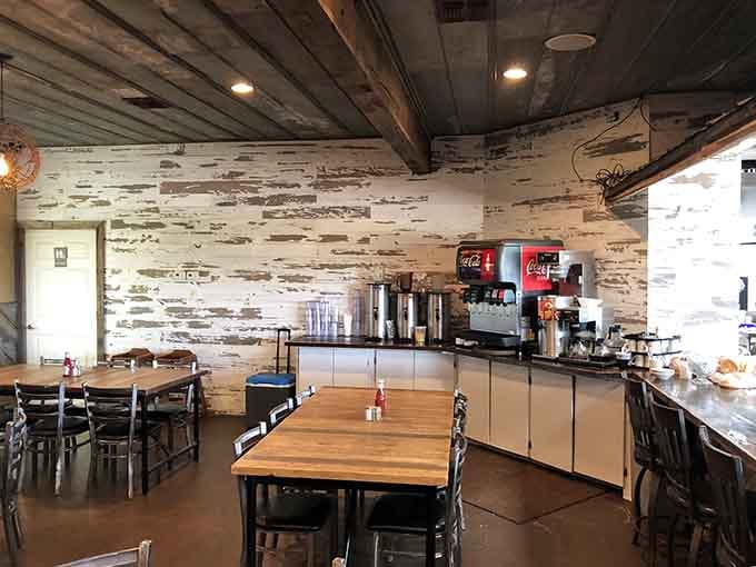 The beverage station with its weathered wood accent wall shows that function and charm can absolutely coexist peacefully.