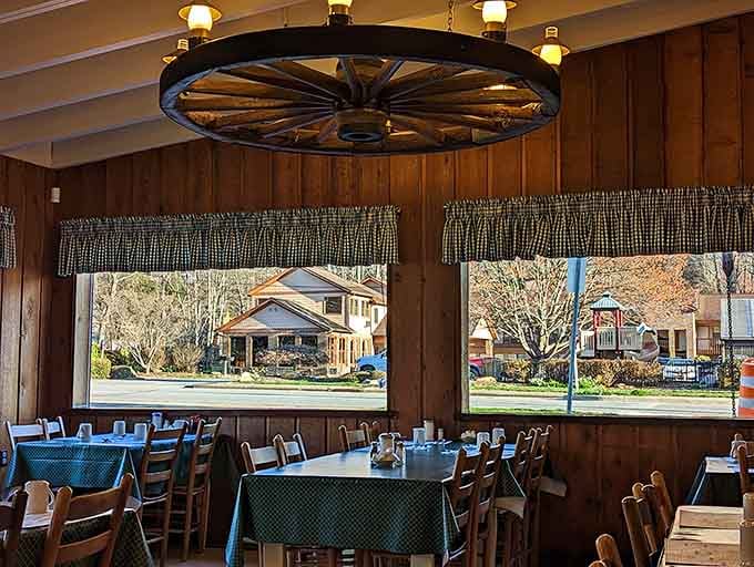 Those wagon wheel light fixtures and checkered tablecloths create an ambiance that says "relax, you're about to eat well."