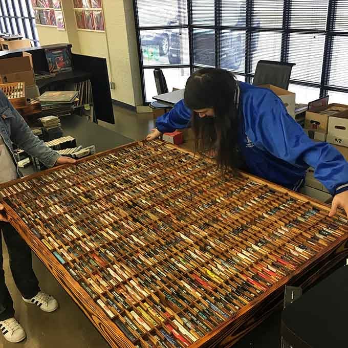 A table full of vintage cassettes awaits anyone nostalgic for rewinding tapes with a pencil.
