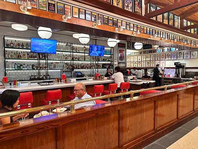 The bar area gleams with promise, offering the perfect perch for solo diners who appreciate good company.