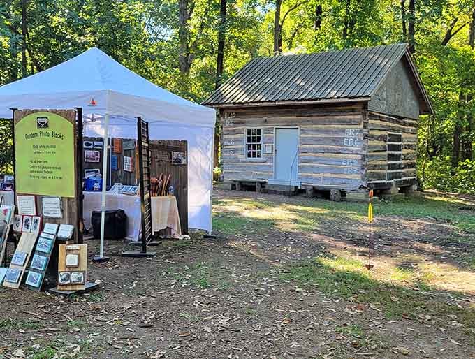 Vendor booths add festive atmosphere while historic cabins provide authentic backdrop for community gatherings and seasonal celebrations.