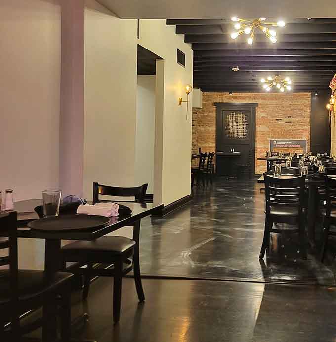 Sleek floors and exposed brick create a space that feels both contemporary and welcoming, never cold or pretentious.