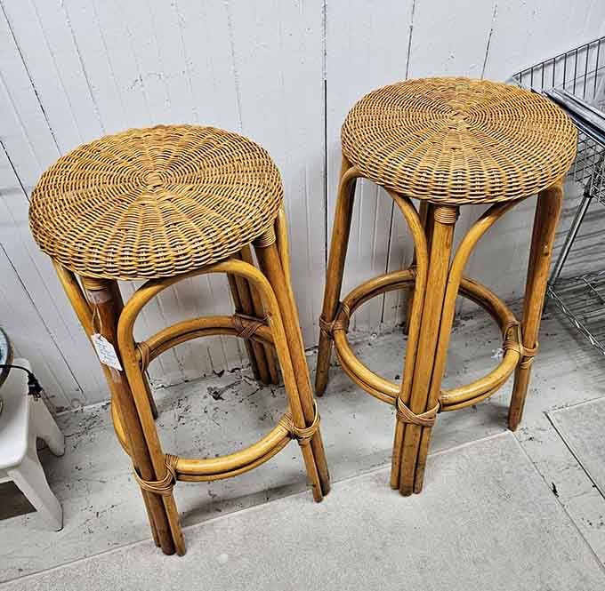 Rattan bar stools that witnessed countless conversations before everyone started staring at their phones instead of each other.